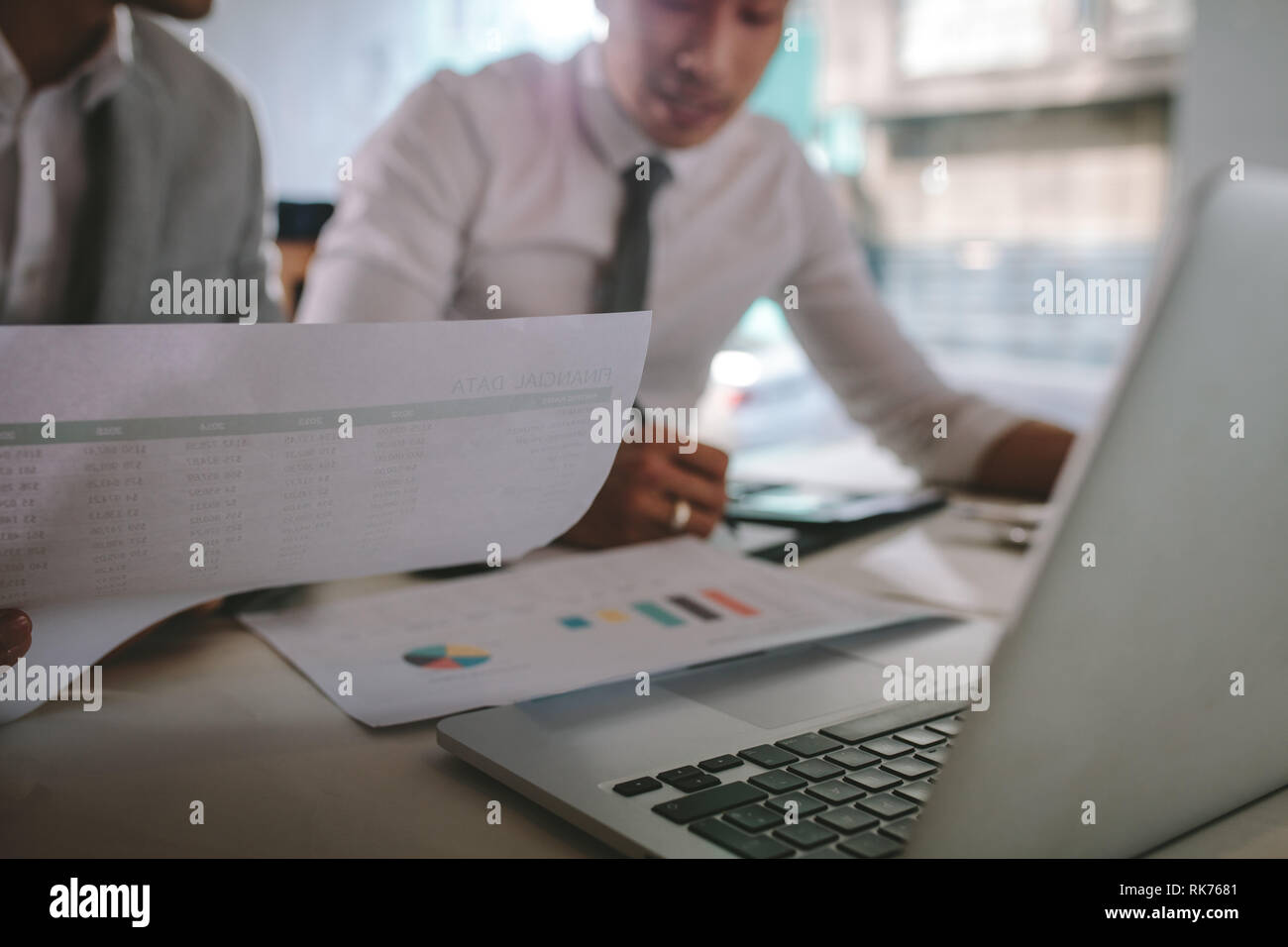 Businessmen doing paperwork together in hi-res stock photography and ...