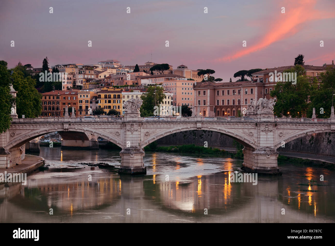 River Tiber and Rome ancient architecture with colorful sky at sunset ...