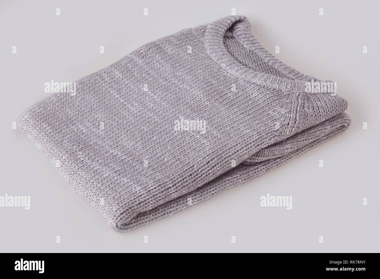 Gray folded knitted sweater with blank tag on white background. Clothes ...