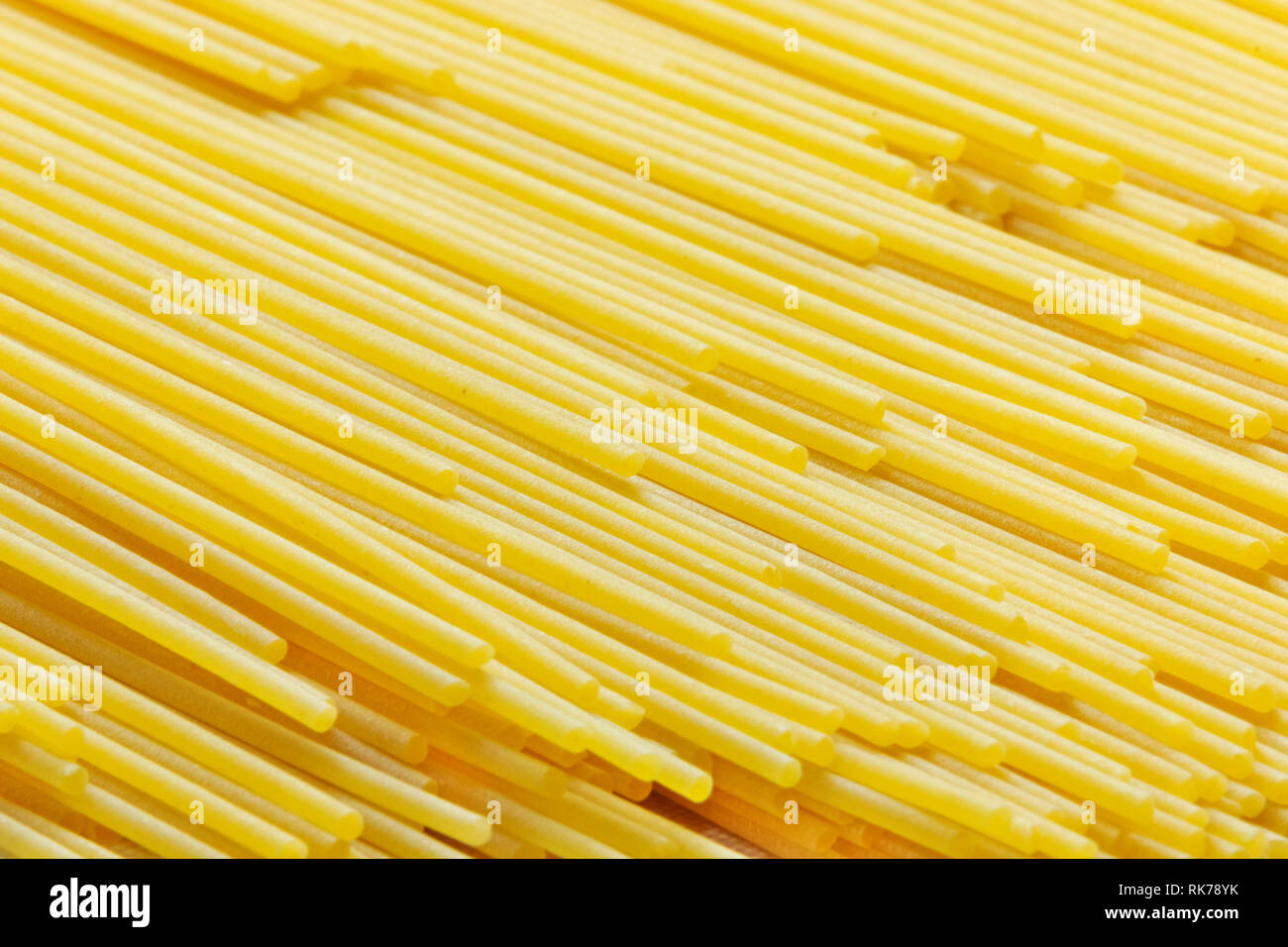 Dried pasta spaghetti background, long and thin solid cylindrical pasta ...