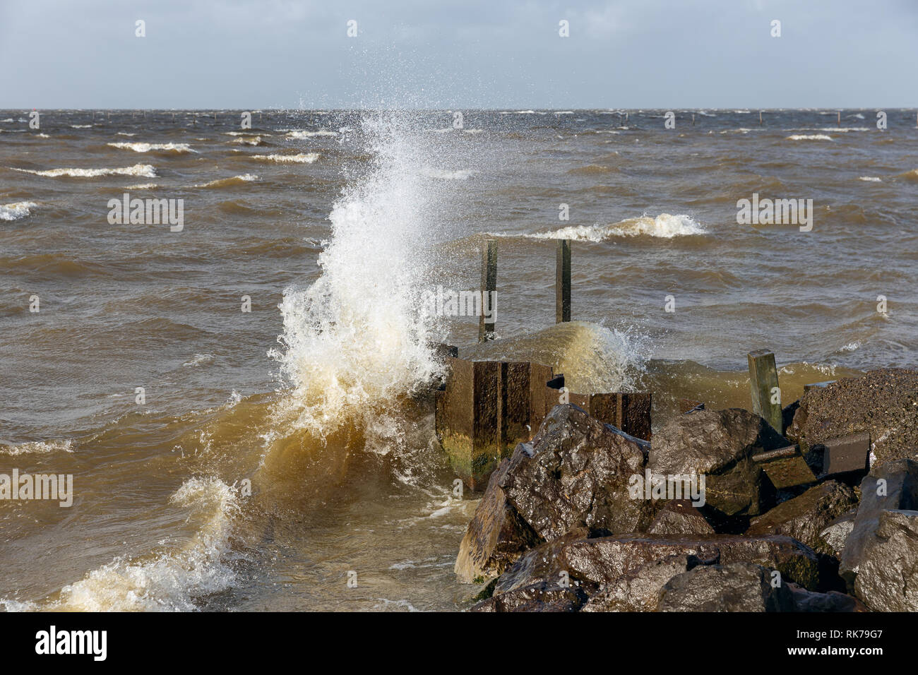 Dutch breakwater with breaking wave in heavy storm Stock Photo - Alamy