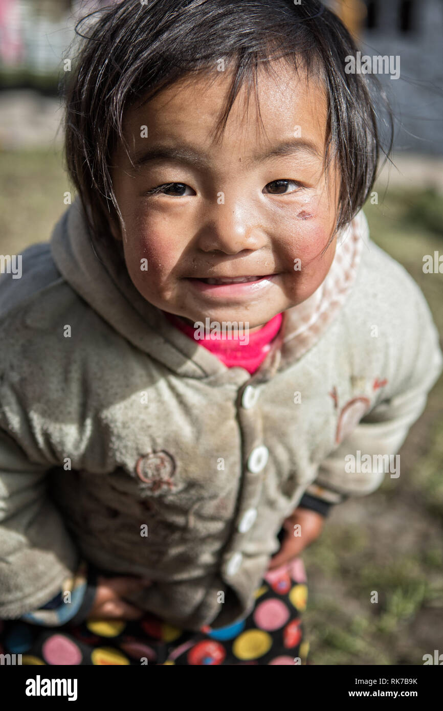 Portrait of a funny little girl in the village of Laya, Gasa District ...