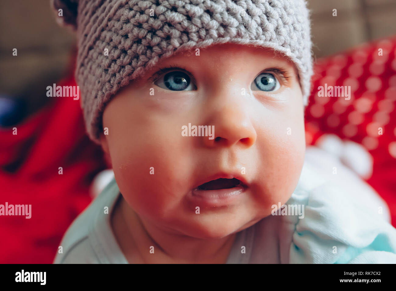 children's fashion - hand-made woolen hat, close up on deep blue eyes ...