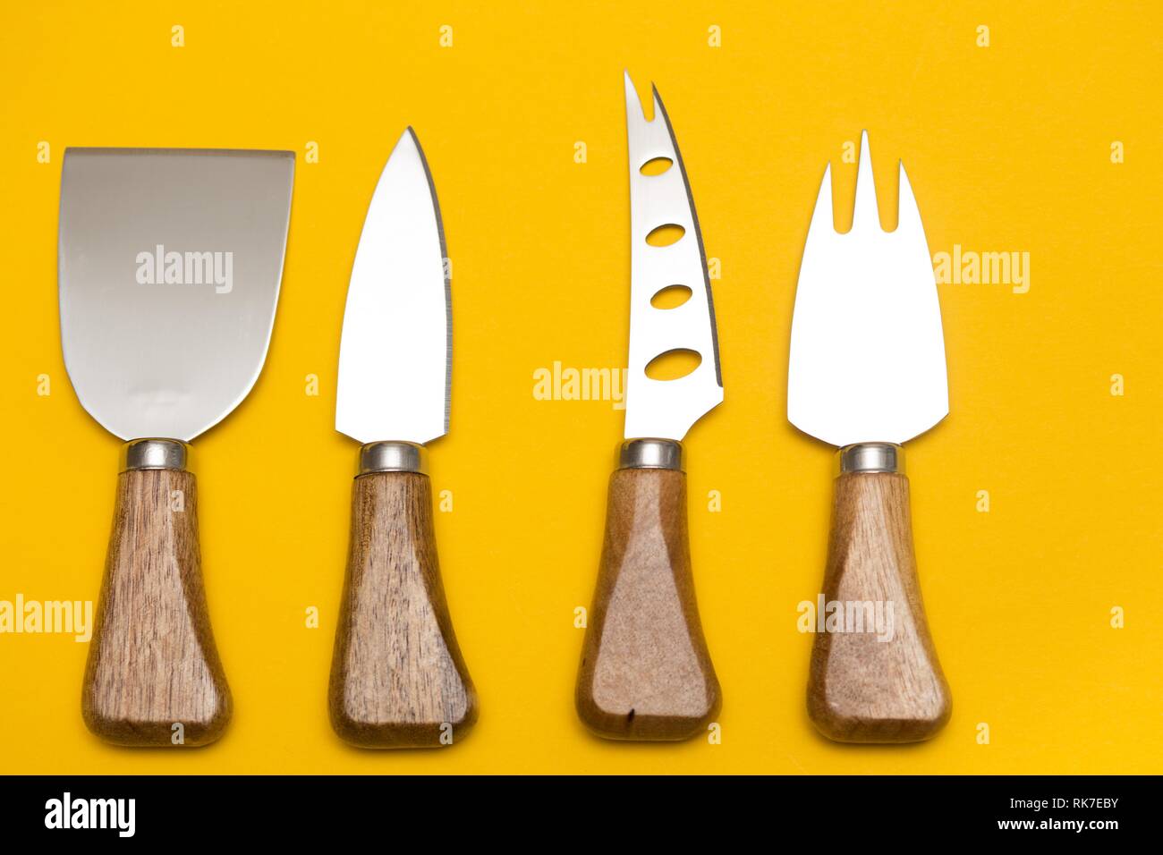 vintage cheese knife set on yellow background Stock Photo - Alamy