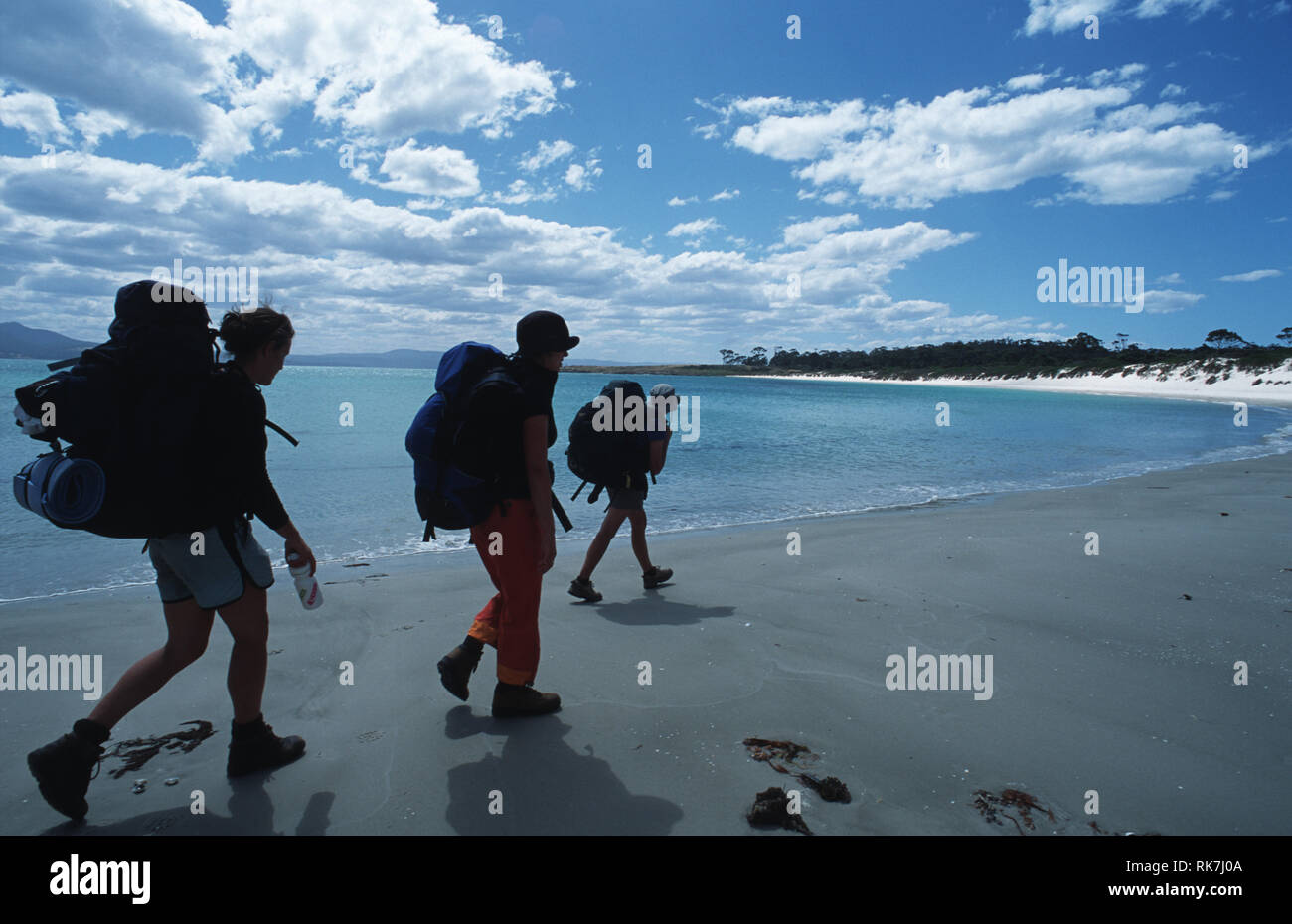 Trekkers walking on the beach Stock Photo - Alamy