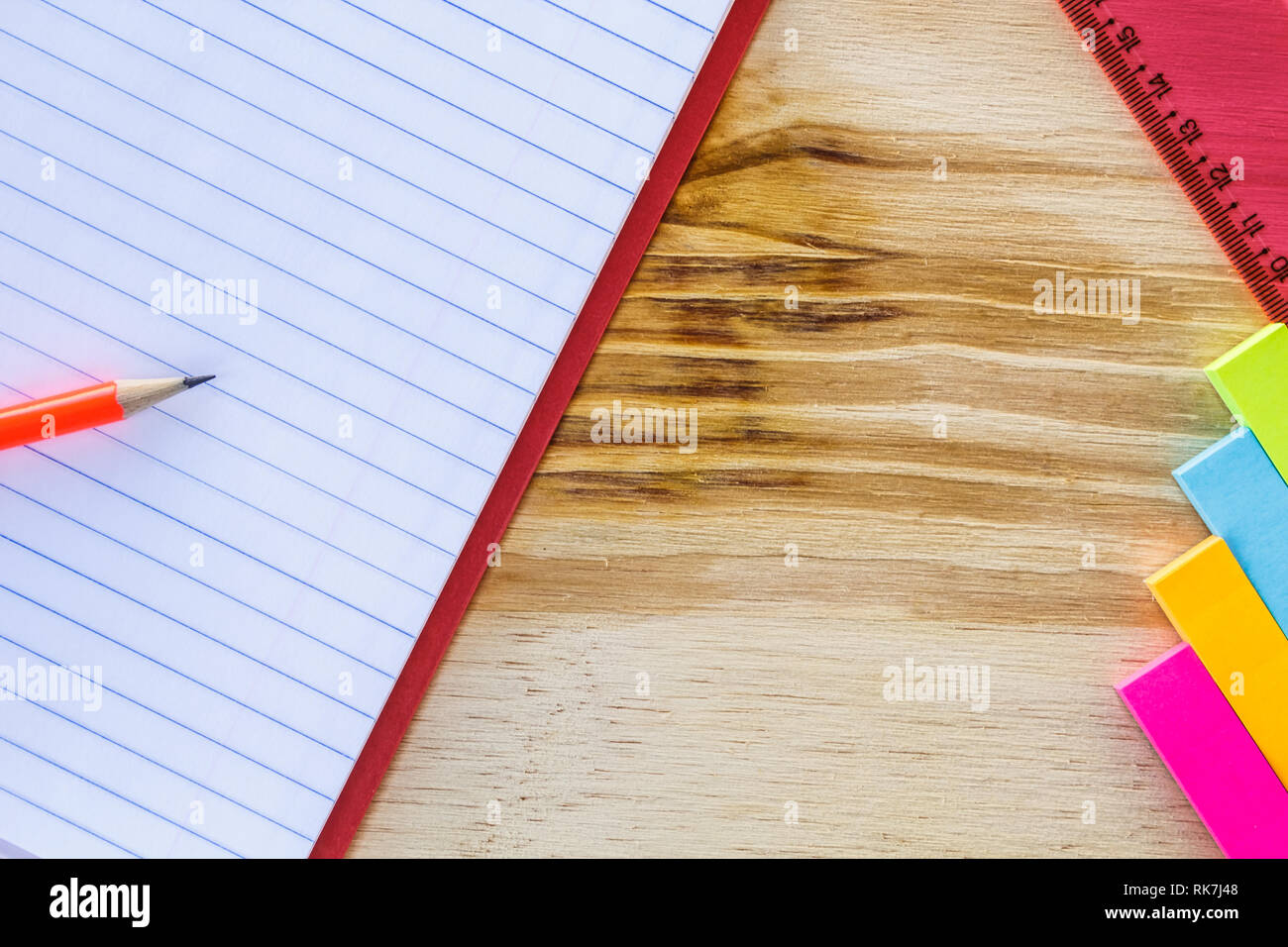 School and drawing supplies, on wooden table. Exercises book, pencils ...