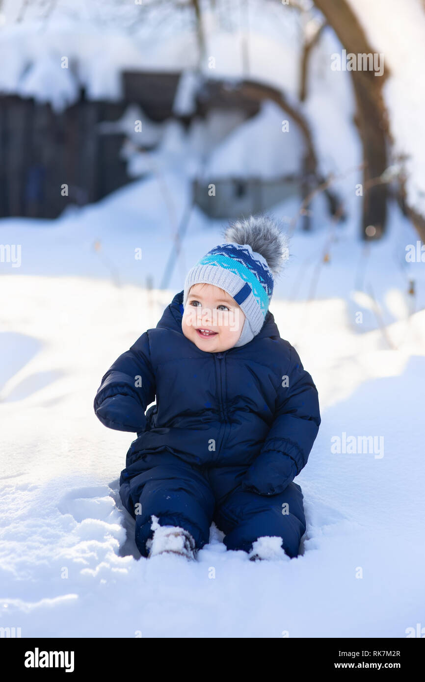 happy smiling baby boy sitting on snow Stock Photo - Alamy