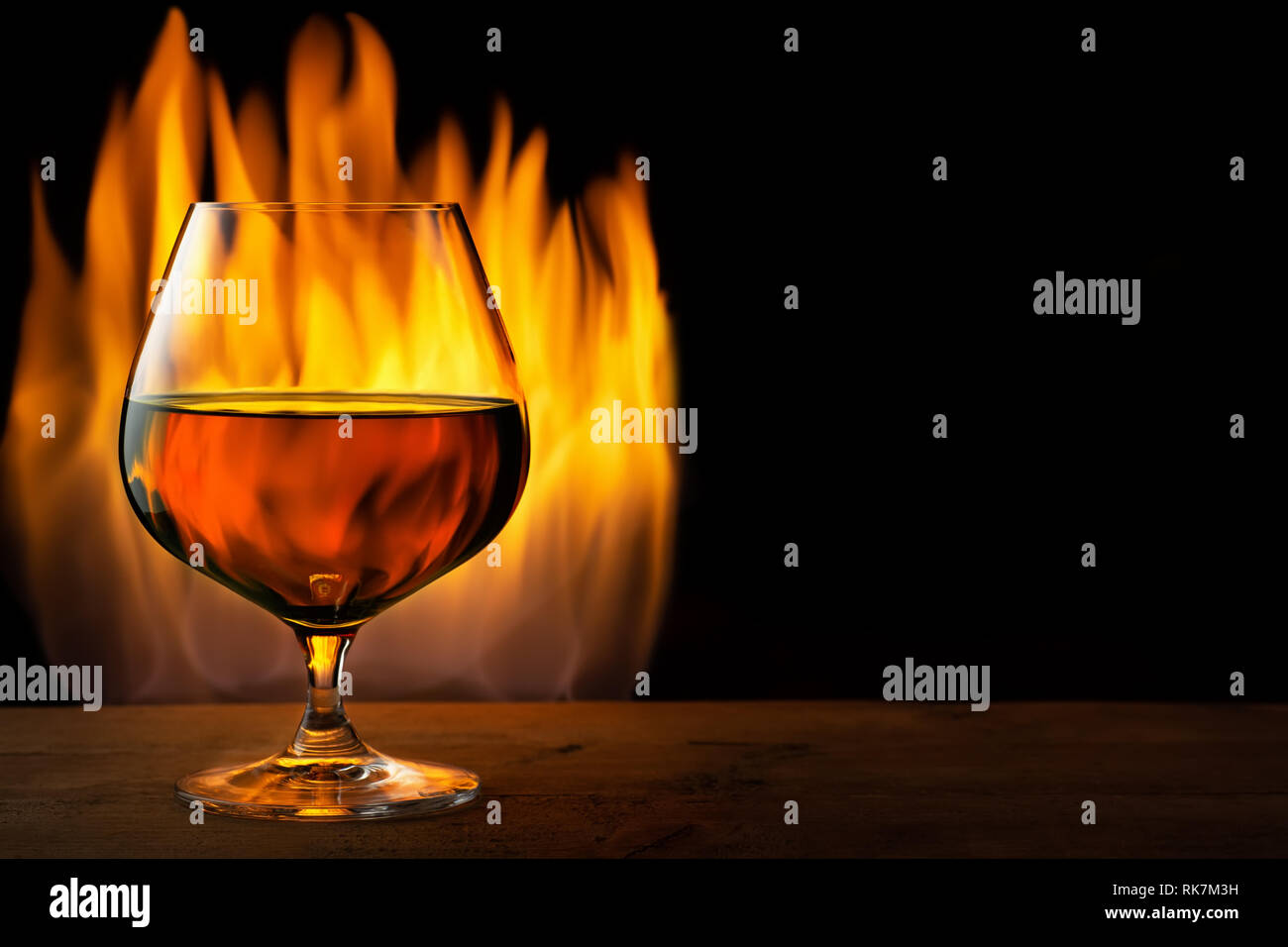 brandy or cognac in snifter glass on fire background Stock Photo - Alamy