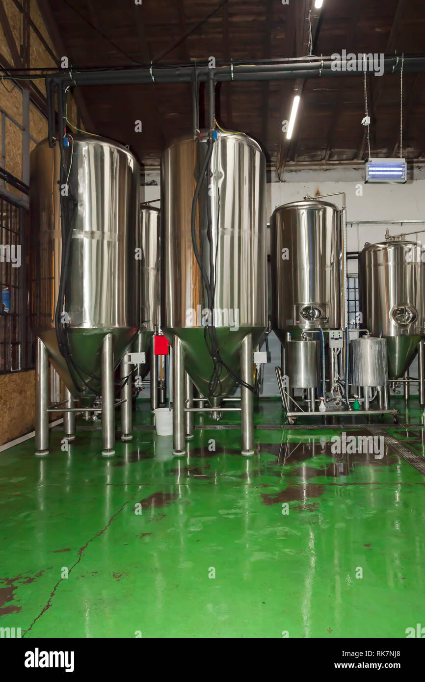 Brewery. Modern beer plant with brewering kettles, tubes and tanks made ...
