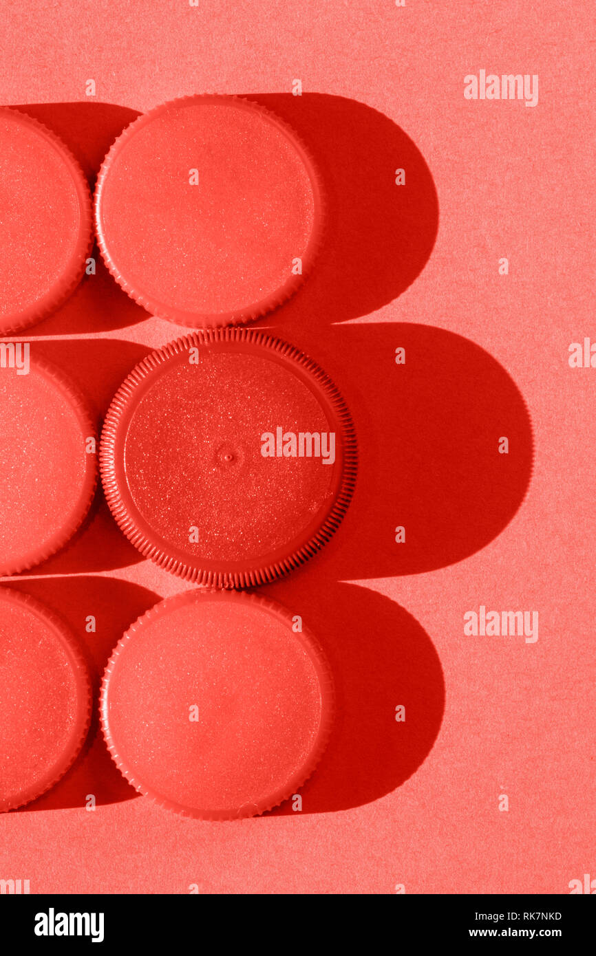 Coral color plastic bottle caps on a coral background, the round caps ...