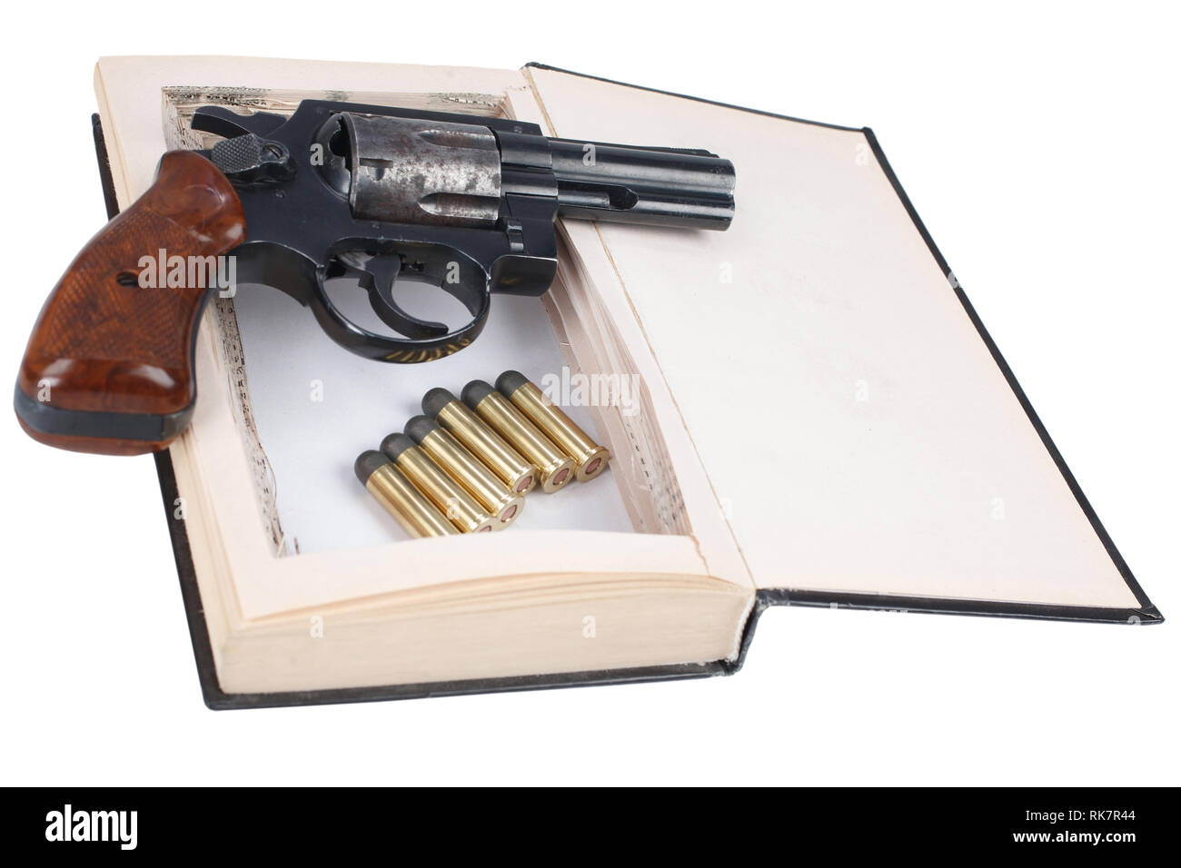 A gun hidden inside a book isolated on white background Stock Photo - Alamy