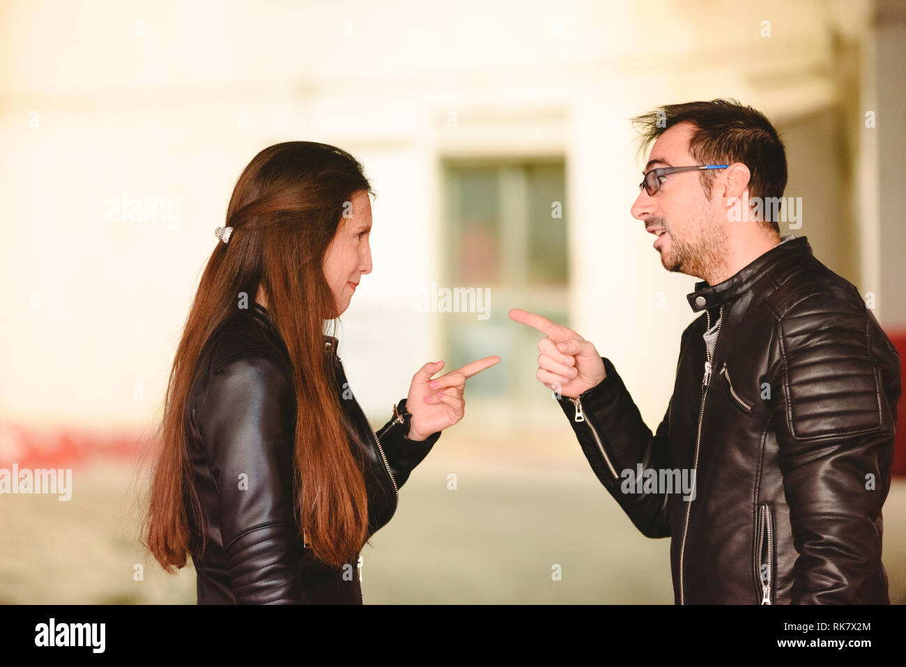 Angry millennial couple arguing and blaming each other of problem ...