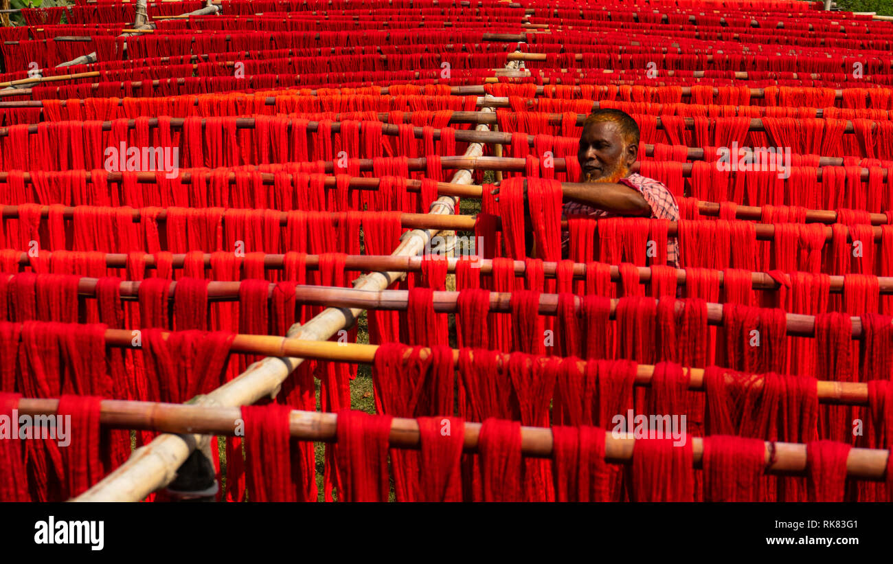 The old man colored threads are drying through conventional way under ...