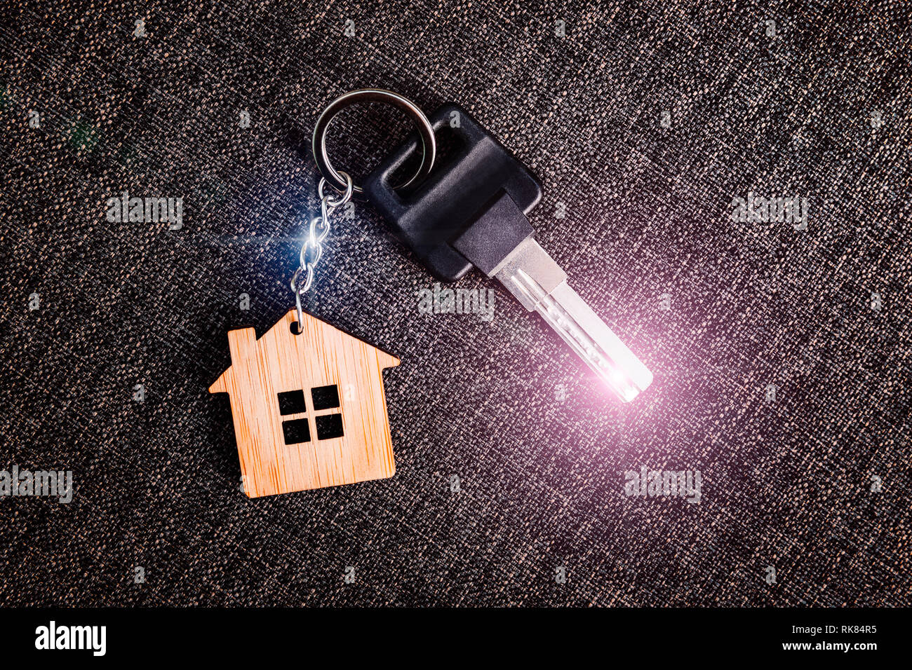 House shaped key ring resting on the carpet for the home or rental ...
