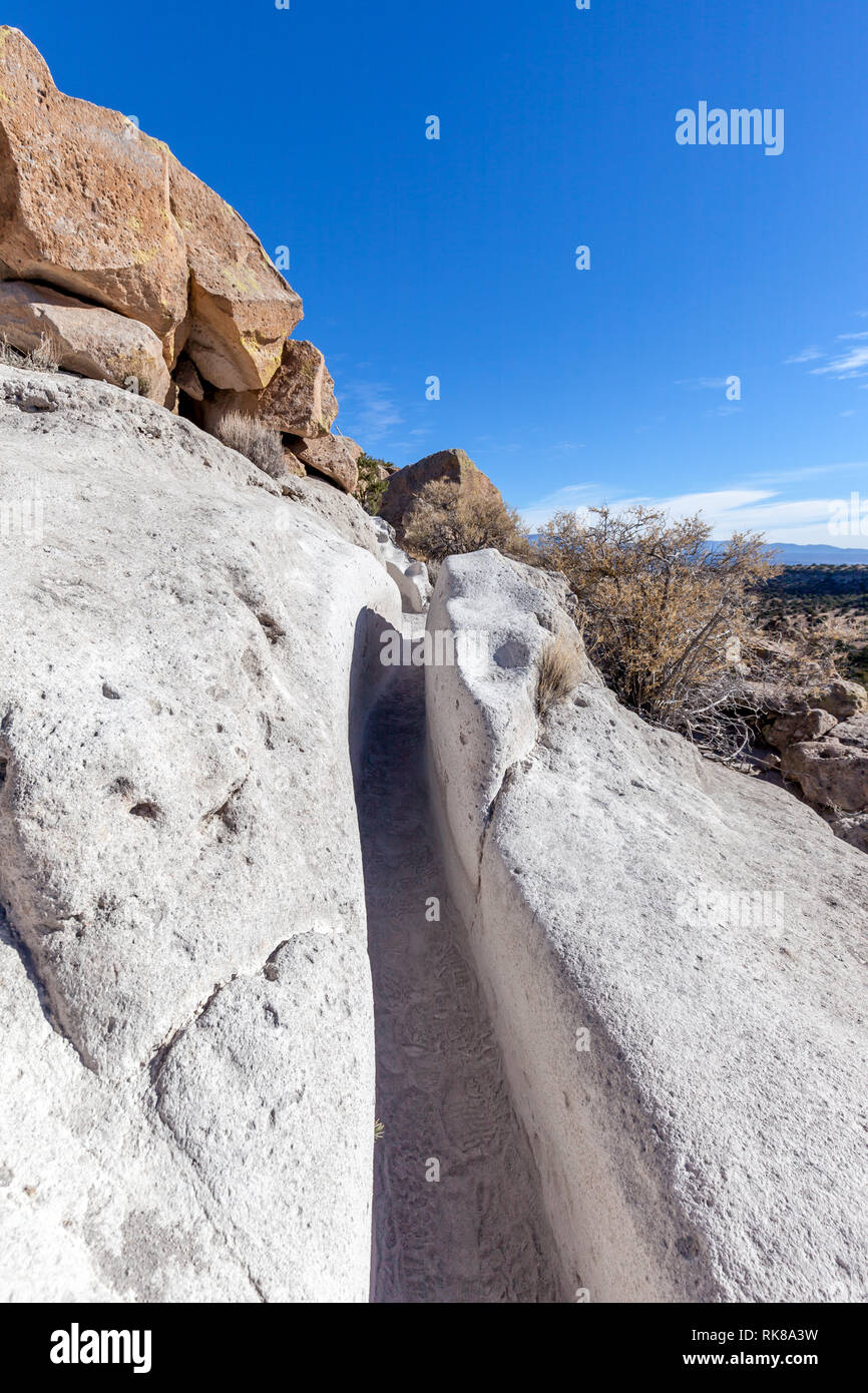 Ancient footpaths are worn into the soft tuff at Tsankawi. Tsankawi is ...