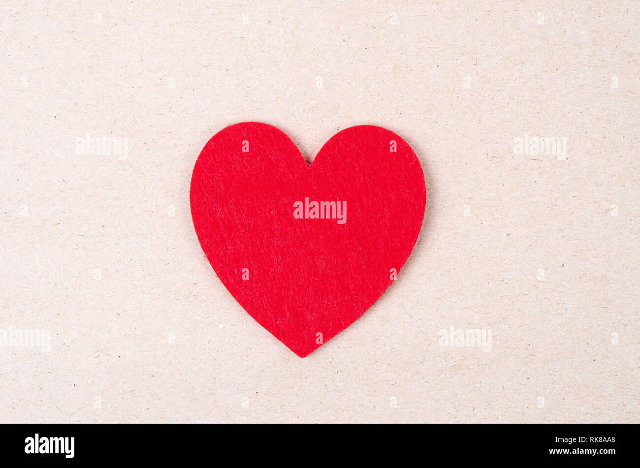 Red fabric heart shape on brown paper background Stock Photo - Alamy