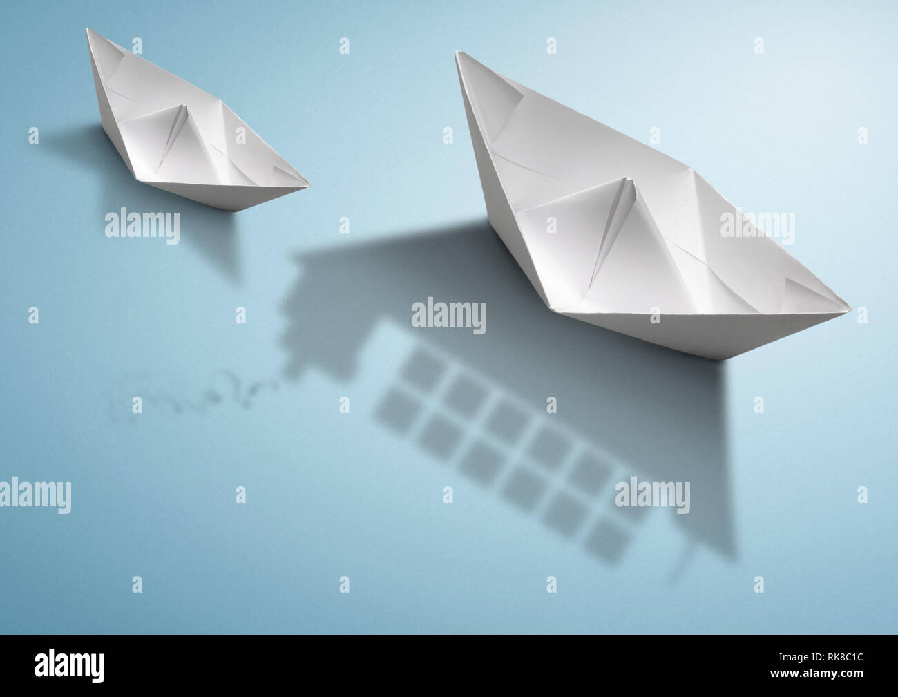 shipping concept, paper boat with container ship shadow Stock Photo - Alamy