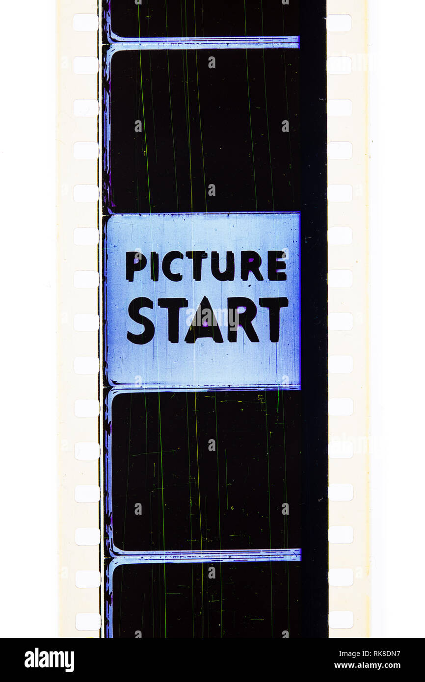 Extreme close up of 35mm movie film strip with picture start text ...