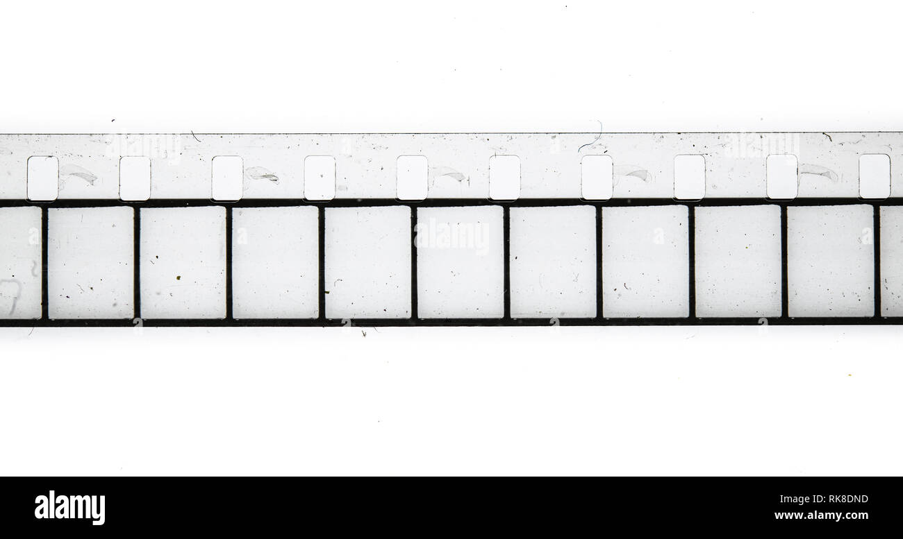 Extreme close up of empty transparent frames on 8mm movie film strip ...