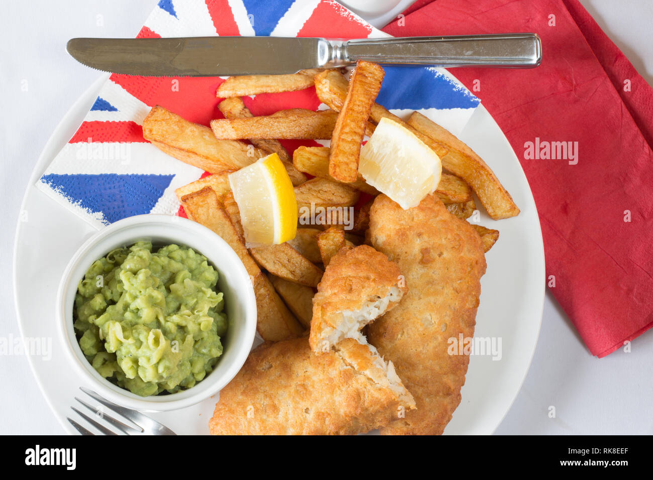 A plate of Traditional English fish and chips with mushy peas Stock Photo - Alamy