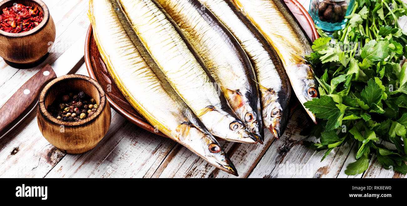 Smoked fish on kitchen board.Smoked saury.Fish food Stock Photo - Alamy