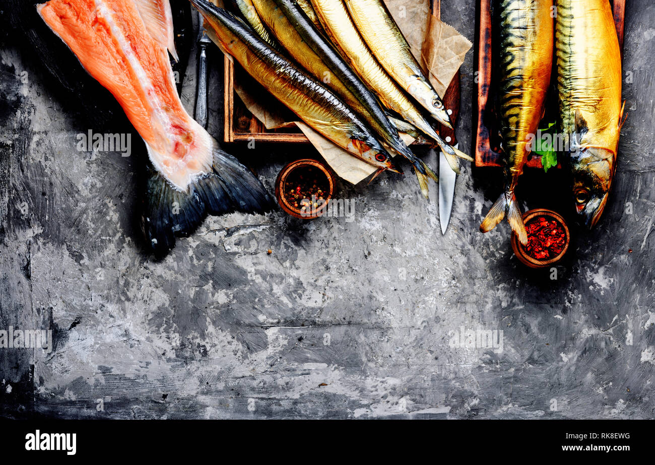 Smoked fish on kitchen board.Smoked mackerel and saury.Fish food Stock ...