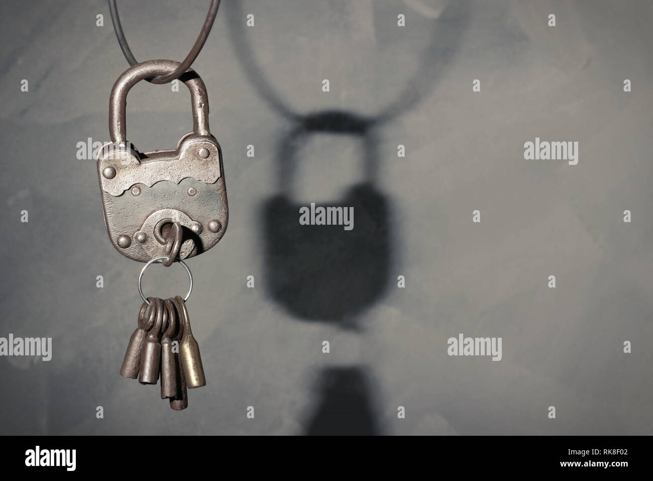 Old antique vintage padlock with key on rustic background Stock Photo ...