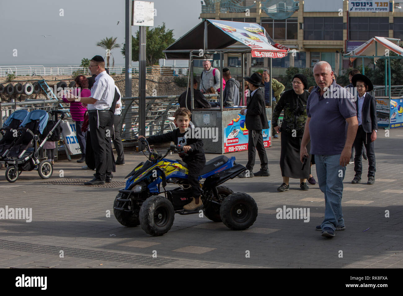 Market at the coast in the centre of Tiberias, Israel with kid on buggy ...