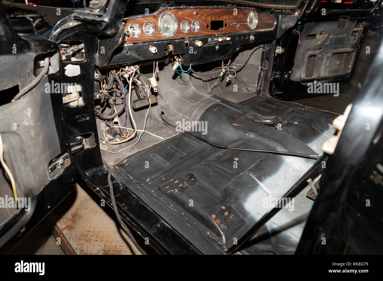 Disassembled car body, inside a black sedan, with parts and interior ...