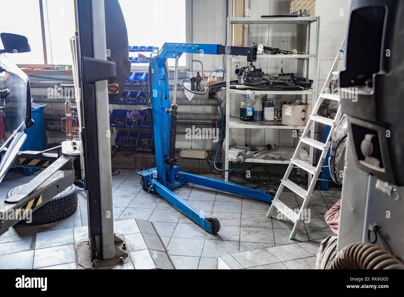 Tool for auto service. Blue crane for repairing the engine and gearbox ...