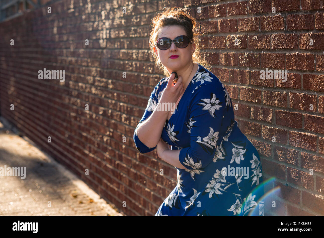 Lady standing against wall hi-res stock photography and images - Alamy