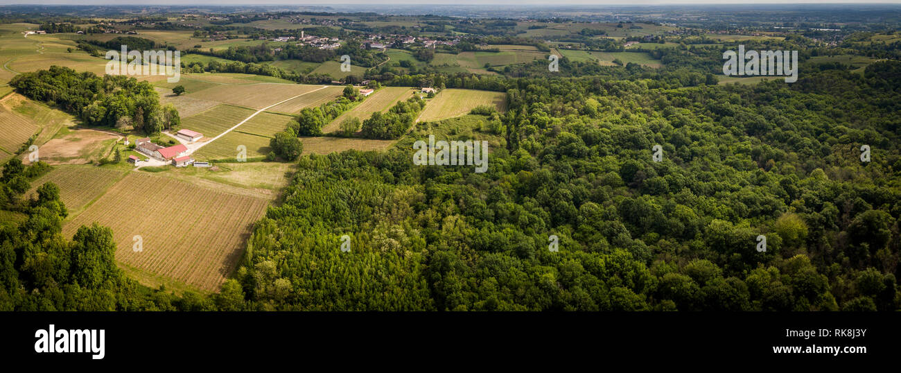 Aerial of flying over a beautiful green forest in a rural landscape ...