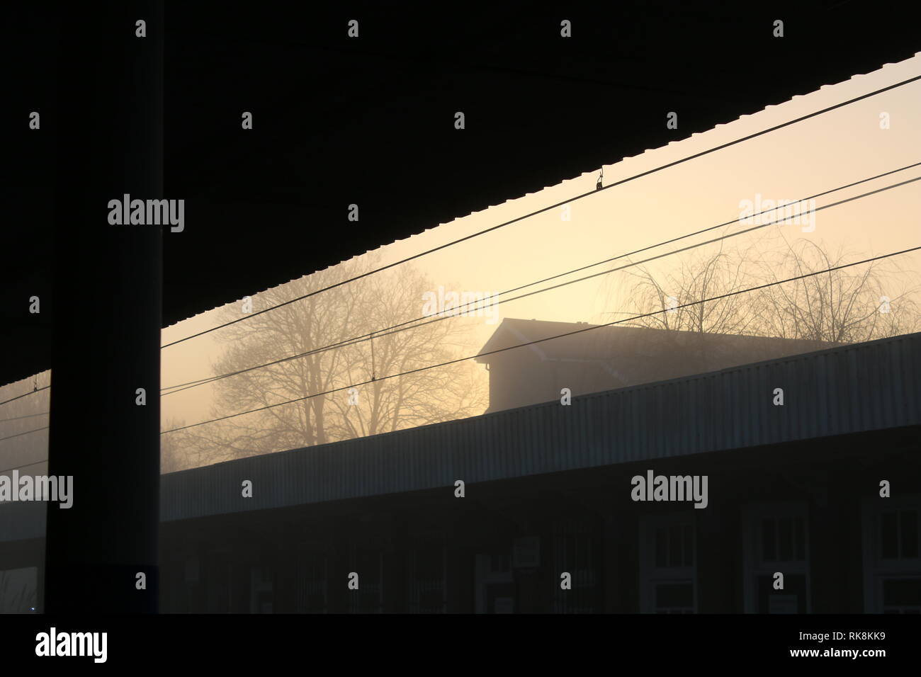 Sunset through fog, trees and power lines at Enfield Chase train ...