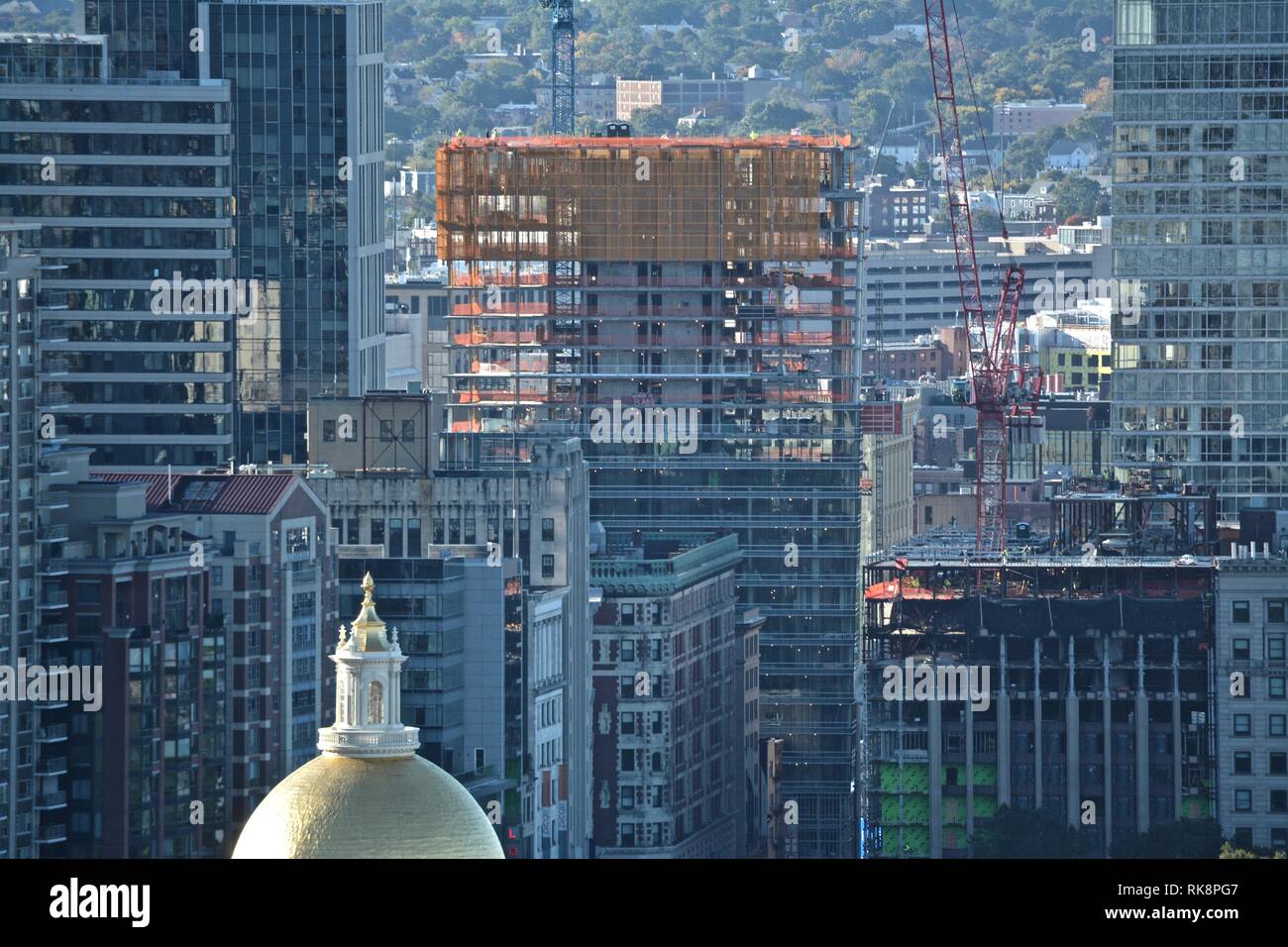 The gold dome of the Massachusetts State House atop Beacon Hill against ...