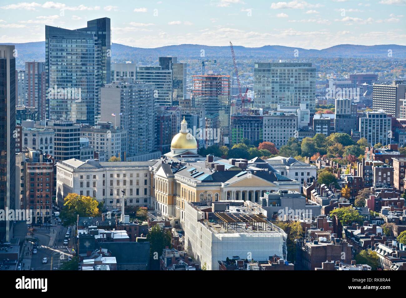 The gold dome of the Massachusetts State House atop Beacon Hill against ...