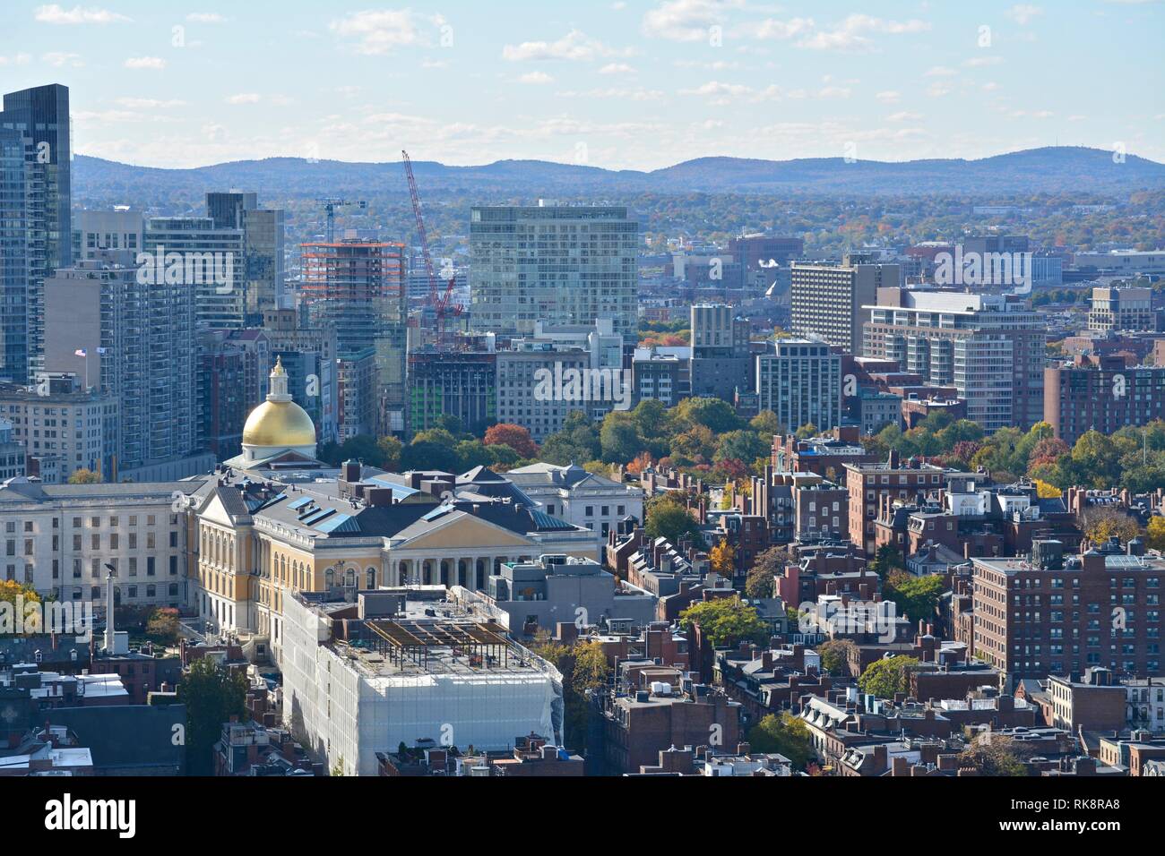 The gold dome of the Massachusetts State House atop Beacon Hill against ...