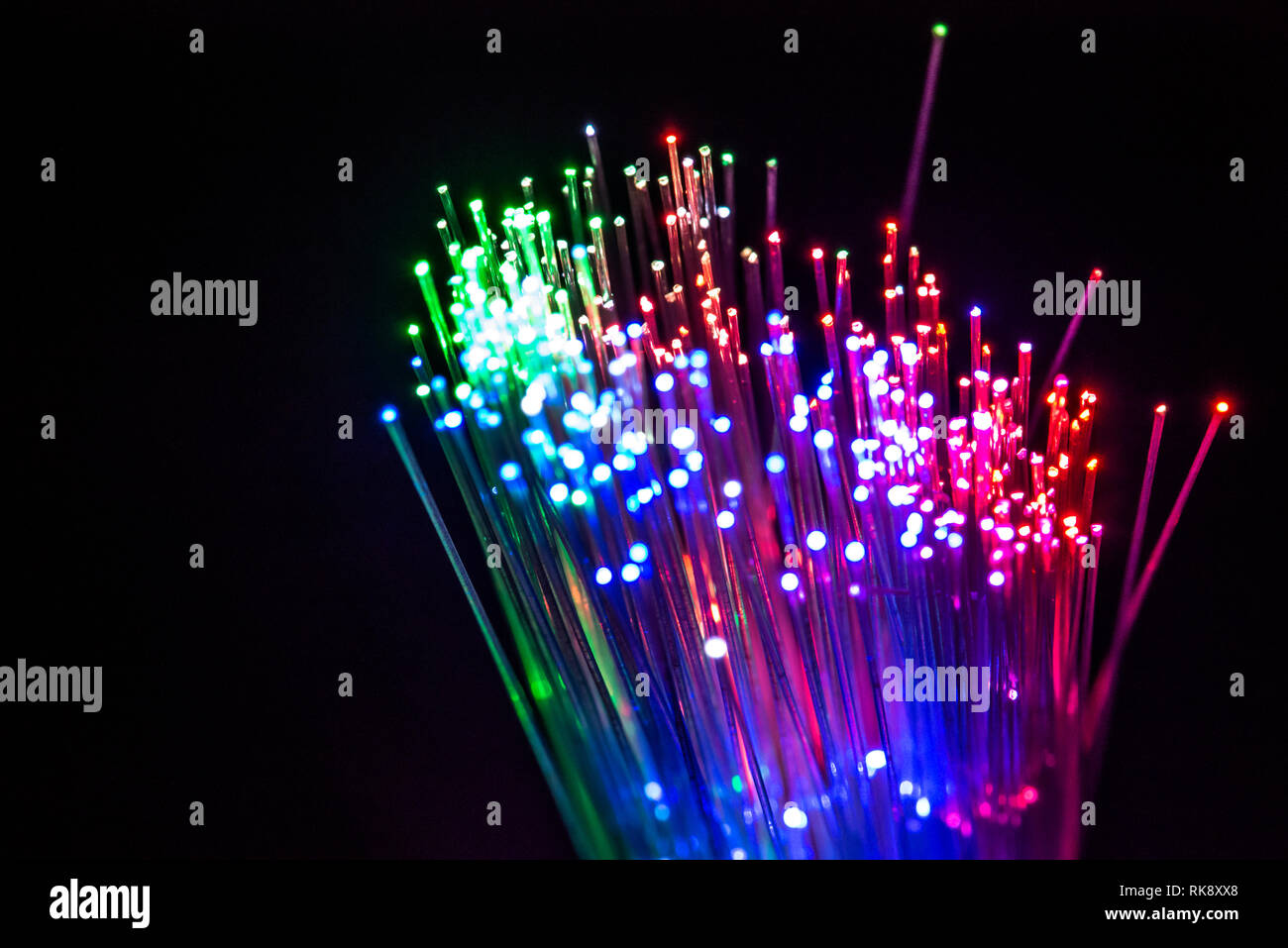 Colourful optic fibers illuminated on dark background. High speed ...