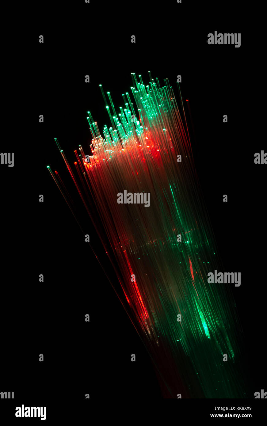Colourful optic fibers illuminated on dark background. High speed ...