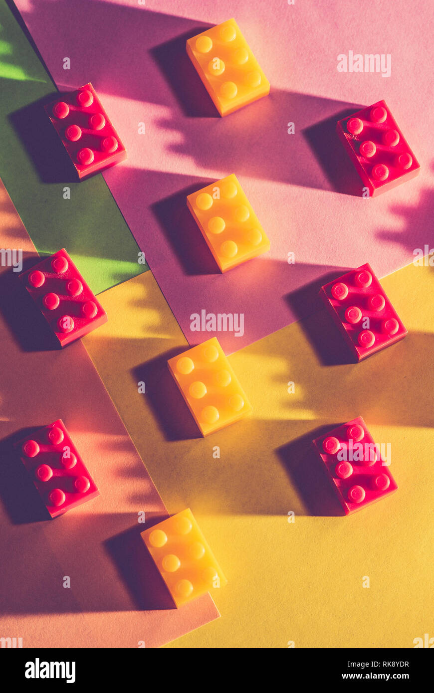 Plastic geometric cubes. Construction toys on geometric shapes paper ...