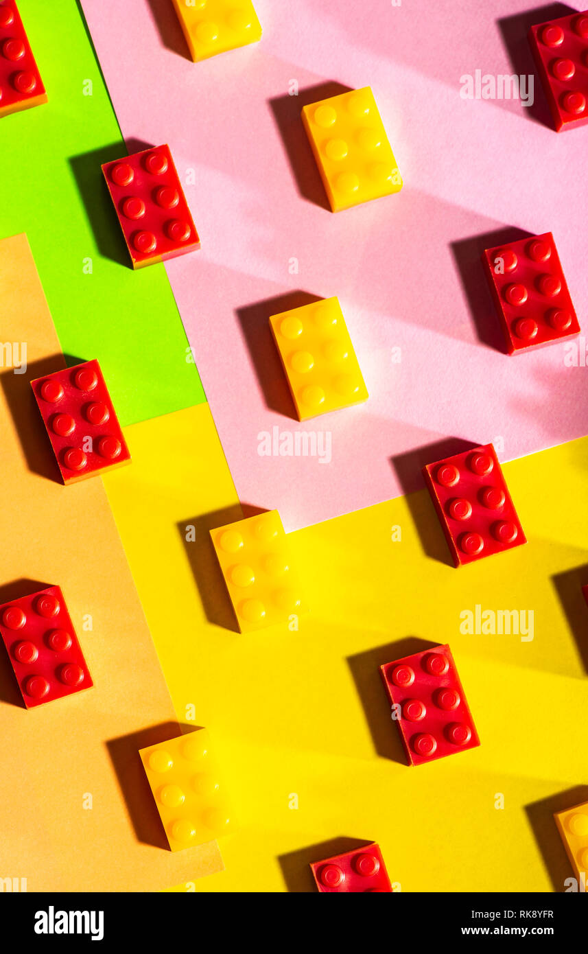 Plastic geometric cubes. Construction toys on geometric shapes paper ...