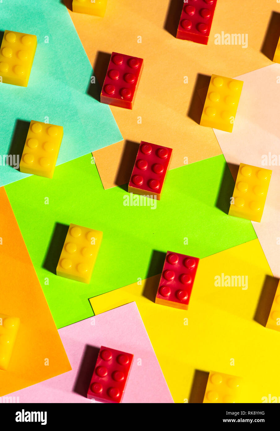 Plastic geometric cubes. Construction toys on geometric shapes paper ...