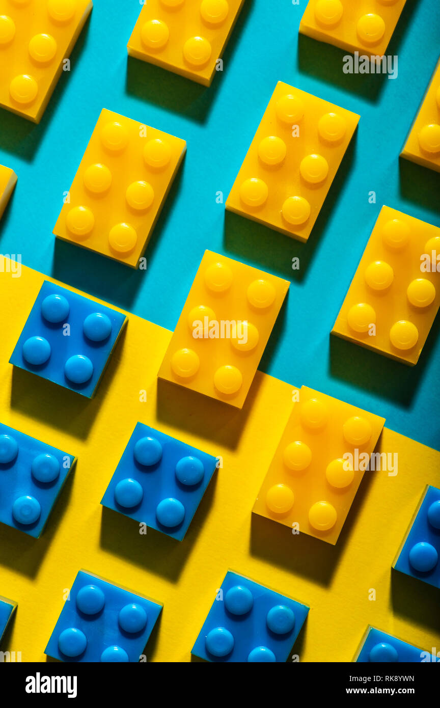 Plastic geometric cubes. Construction toys on geometric shapes paper ...