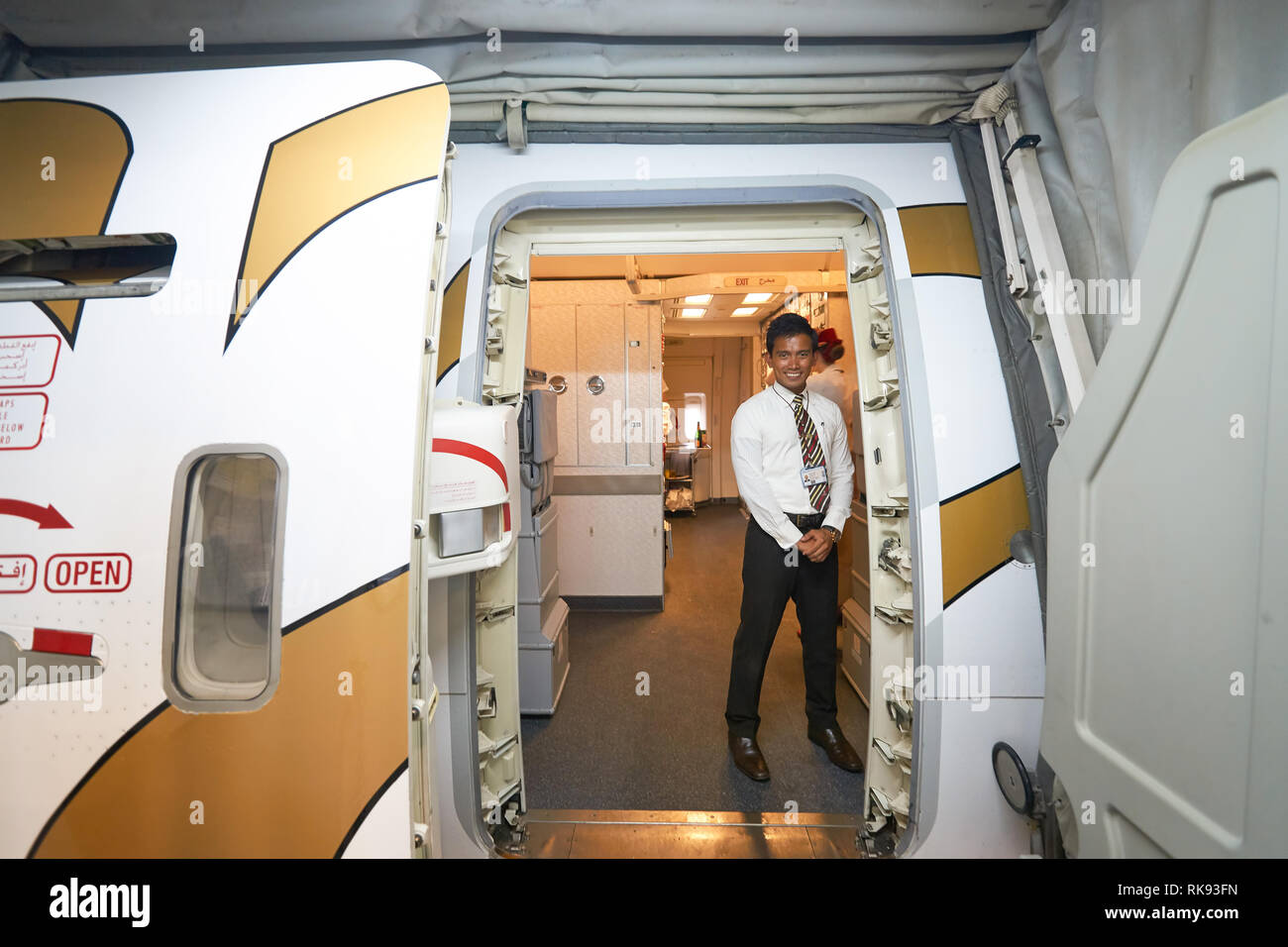 DUBAI, UAE - MARCH 09, 2016: Emirates crew member meet passengers on ...