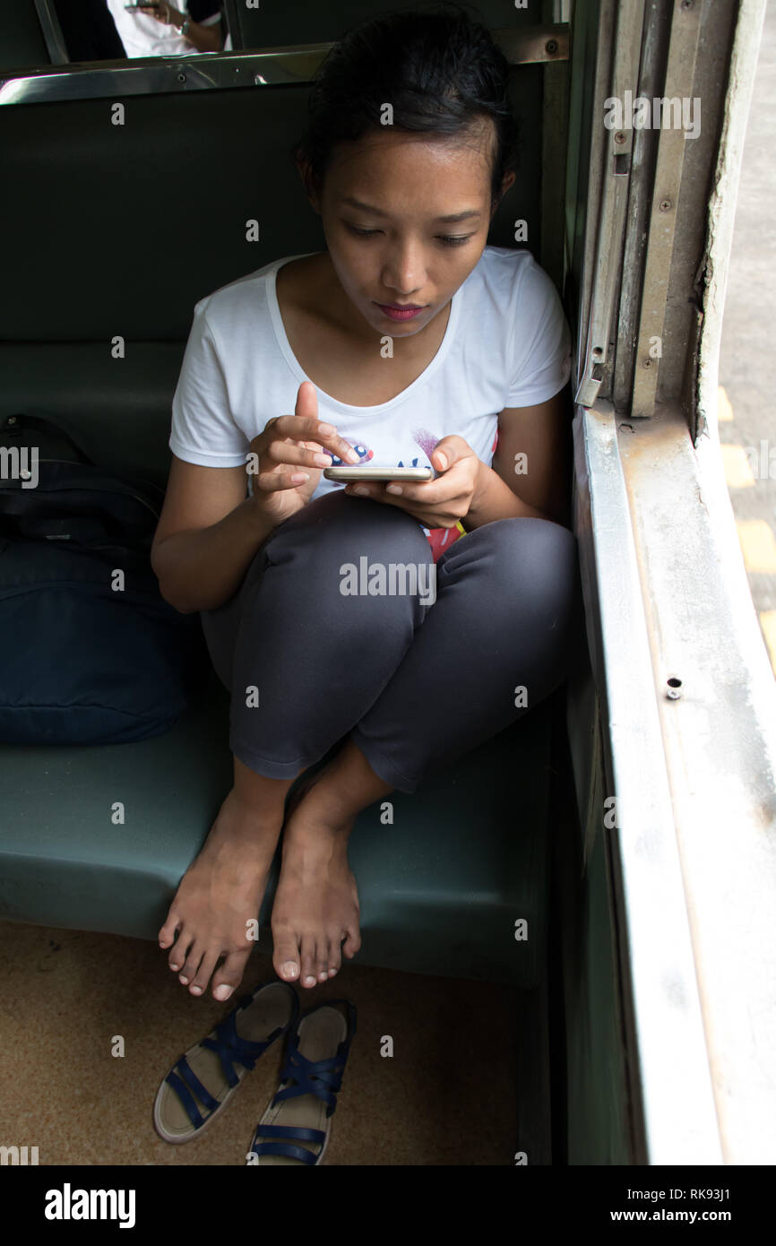 A Young Woman With Mobile Phone Rides In Old Train Asian Girl With