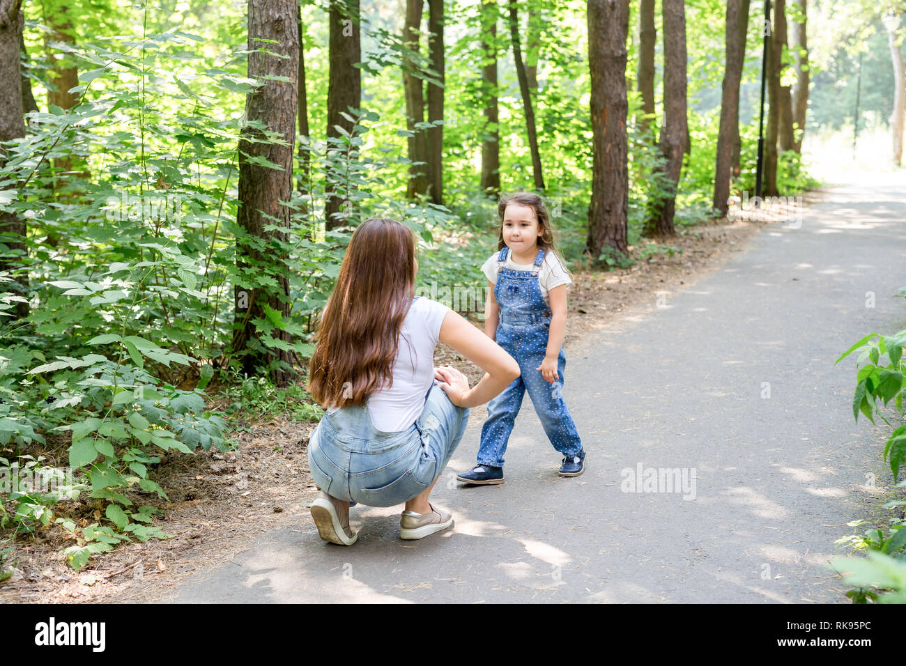 Family, parenthood and nature concept - Mother with daughter having fun ...