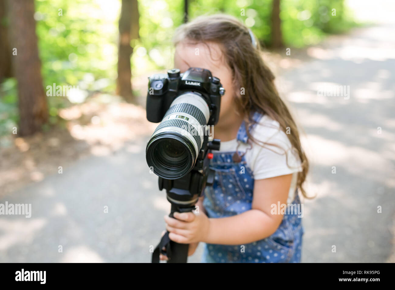 Hobby, profession, children and photographer concept - child with camera in forest Stock Photo ...