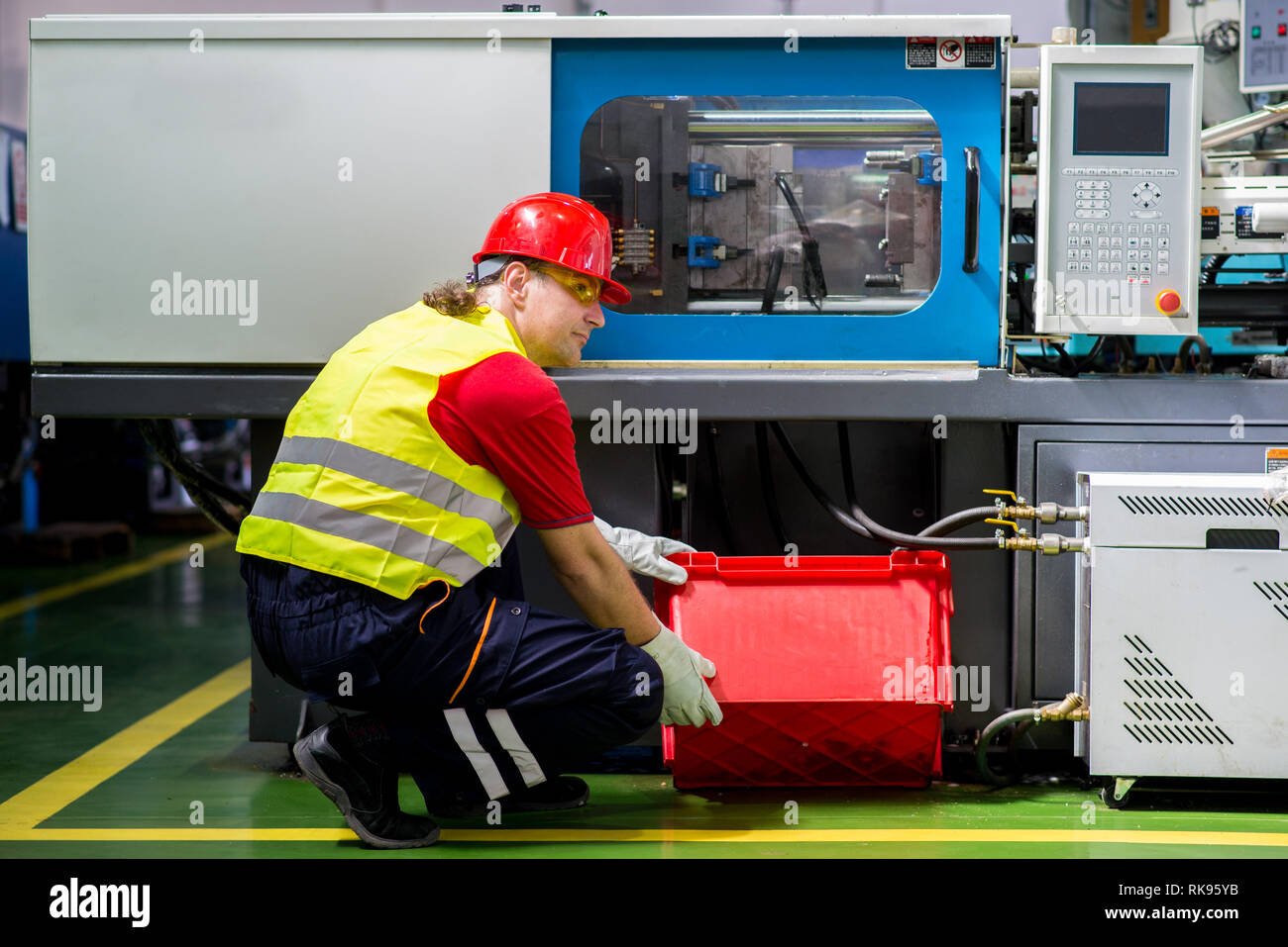 Factory worker maintaining a factory machine Stock Photo - Alamy