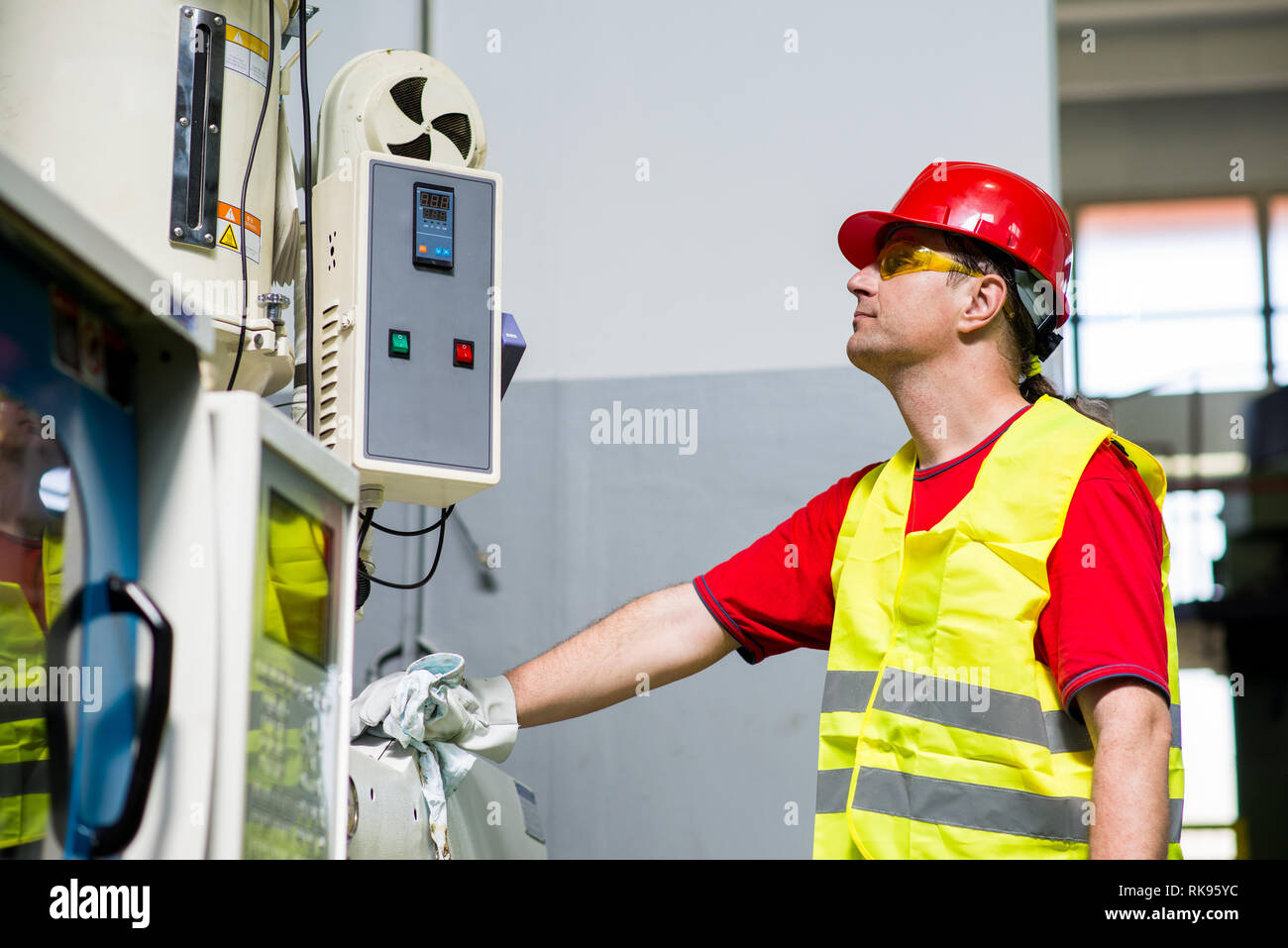 Factory worker operating factory machine Stock Photo - Alamy
