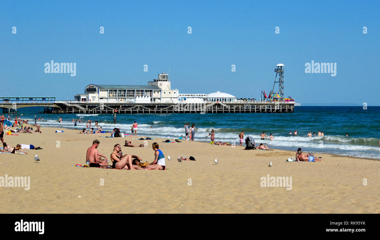 People on the beach in front of Bournemouth Pier, Bournemouth, England ...