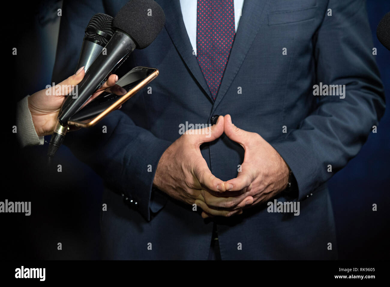 Journalist ask questions to politician with clasped hands during the ...
